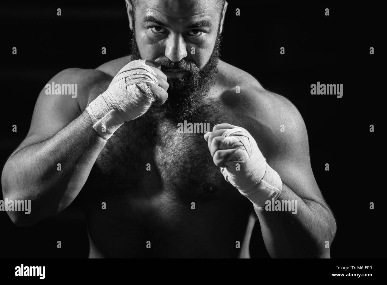 man boxing workout on ring. Caucasian male boxer in black gloves Stock ...