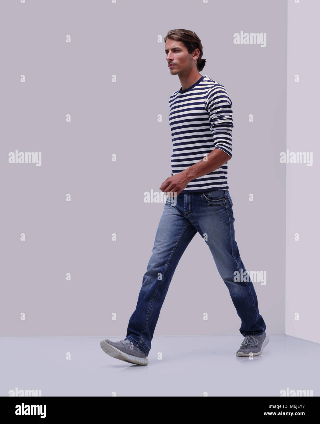 Side view.strong young man goes forward Stock Photo - Alamy