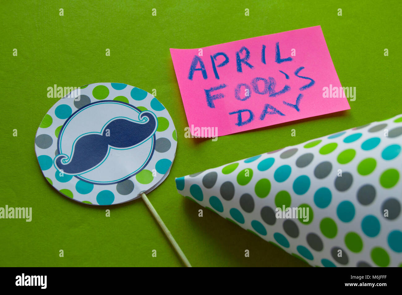 Cap, topper with mustache, April fool's day lettering on green ...