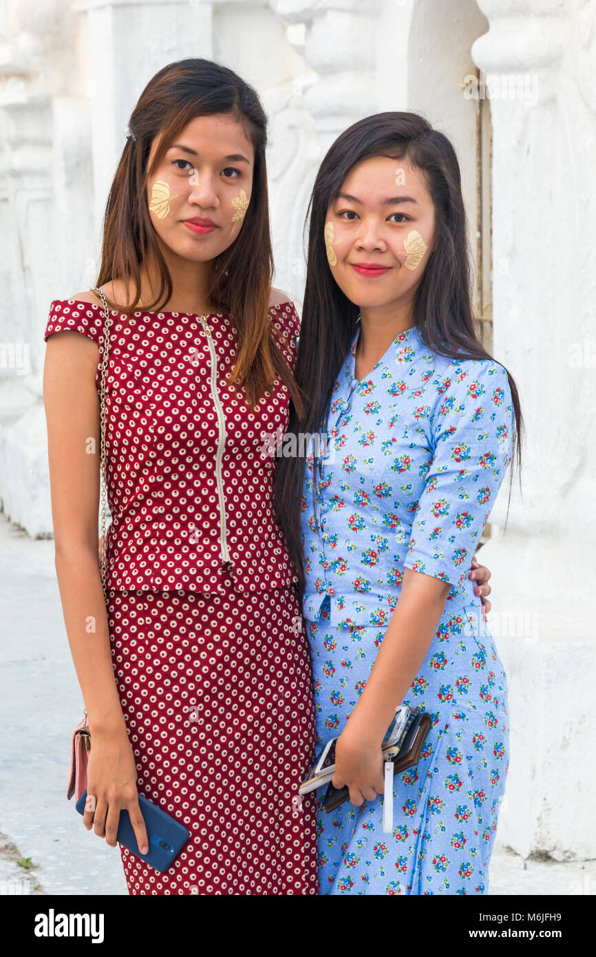 Two pretty young women with thanaka on cheeks posing for photos at ...