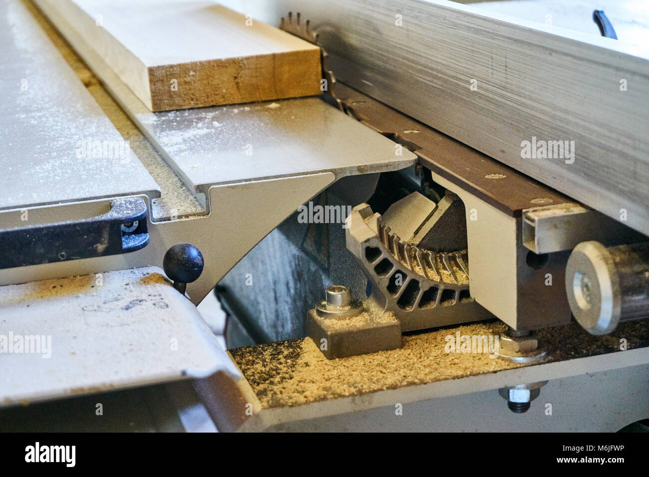 Close-up view of oak wood plank on table saw, highlighting the texture ...