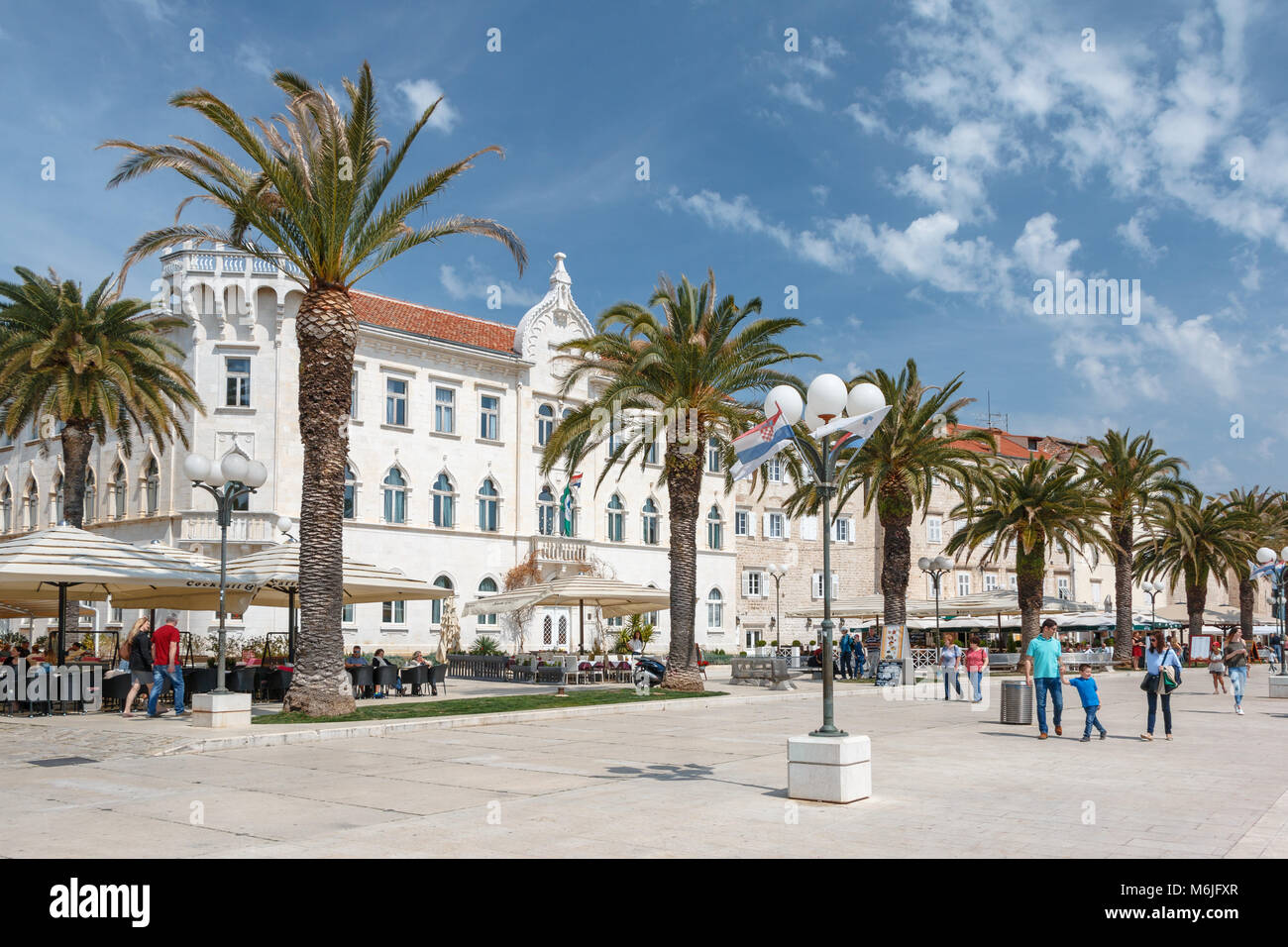 The waterfront esplanade with palm trees in Trogir, Croatia in spring ...