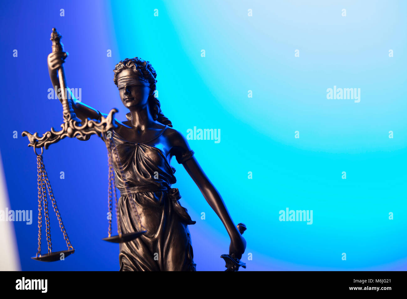 Lady of justice - Themis statue on blue background. Place for text ...