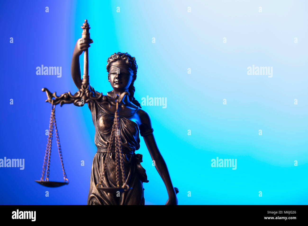 Lady of justice - Themis statue on blue background. Place for text ...