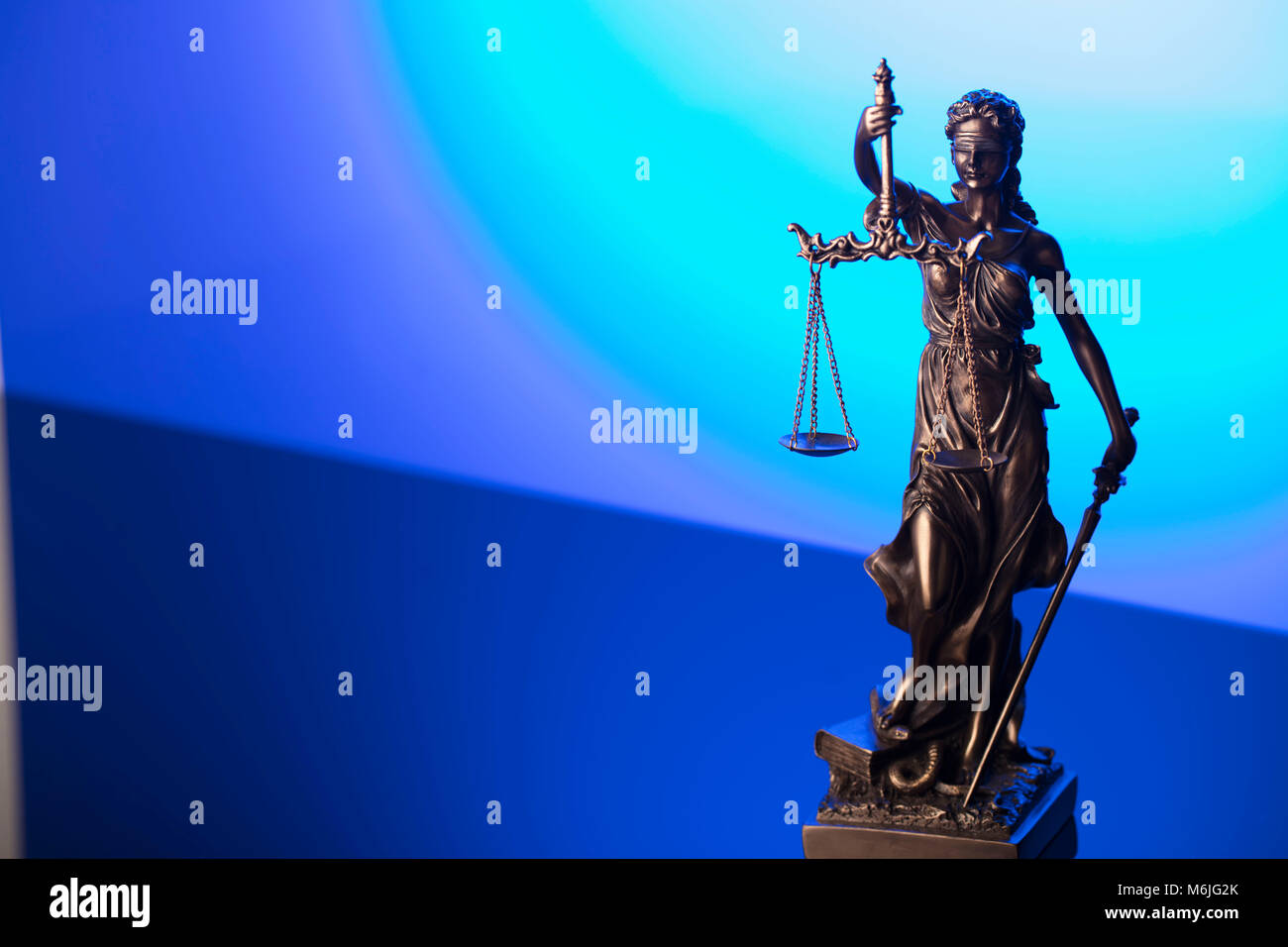 Lady of justice - Themis statue on blue background. Place for text ...