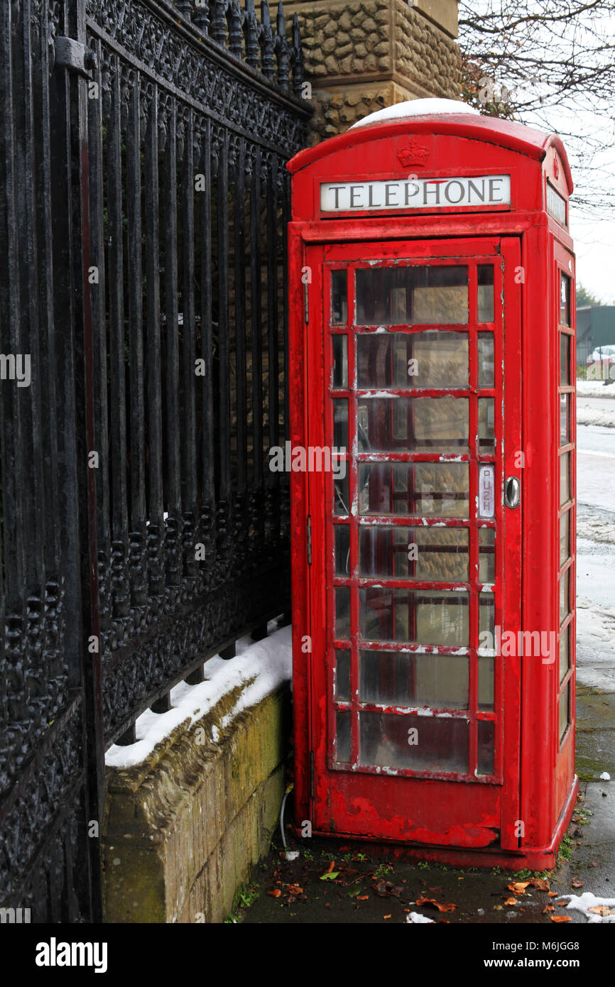 A traditional telephone box by the fence at the entrance to Edinburgh ...