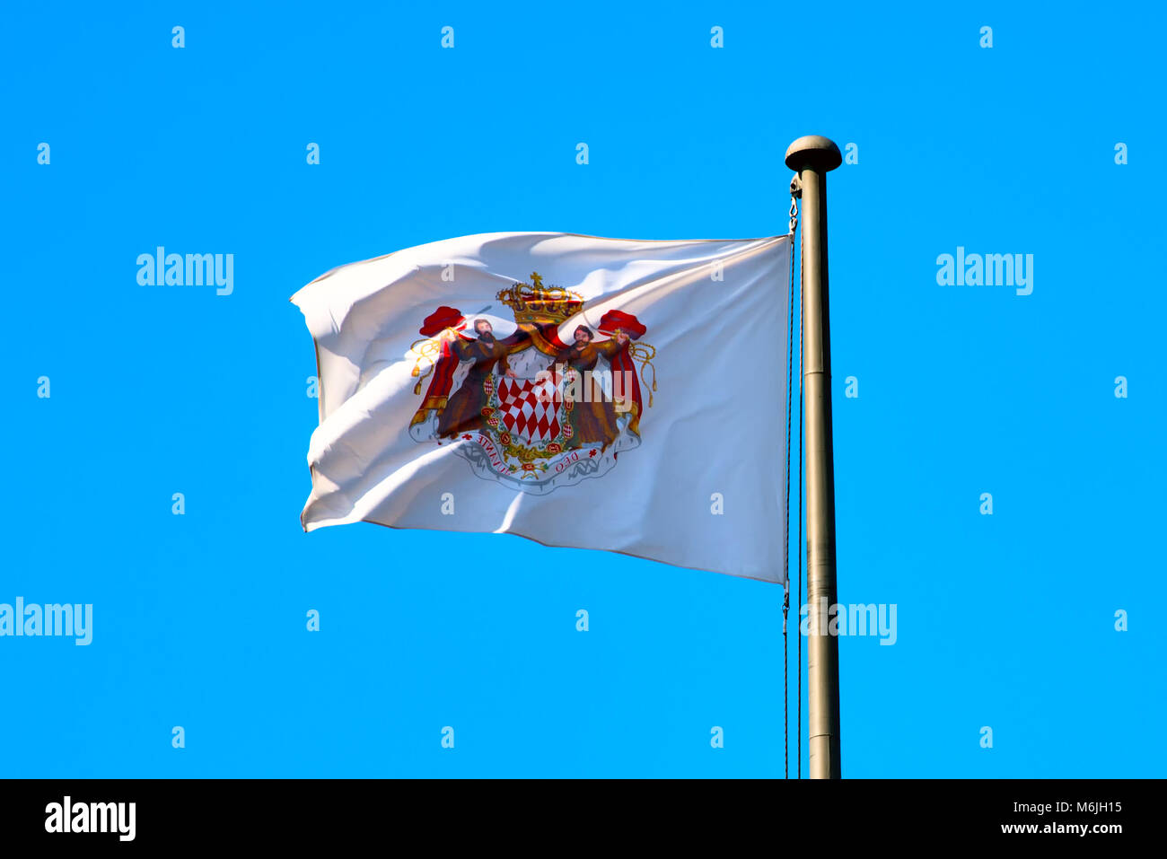 MONACO. flag with the coat of arms of Monaco over the prince's dwarf ...