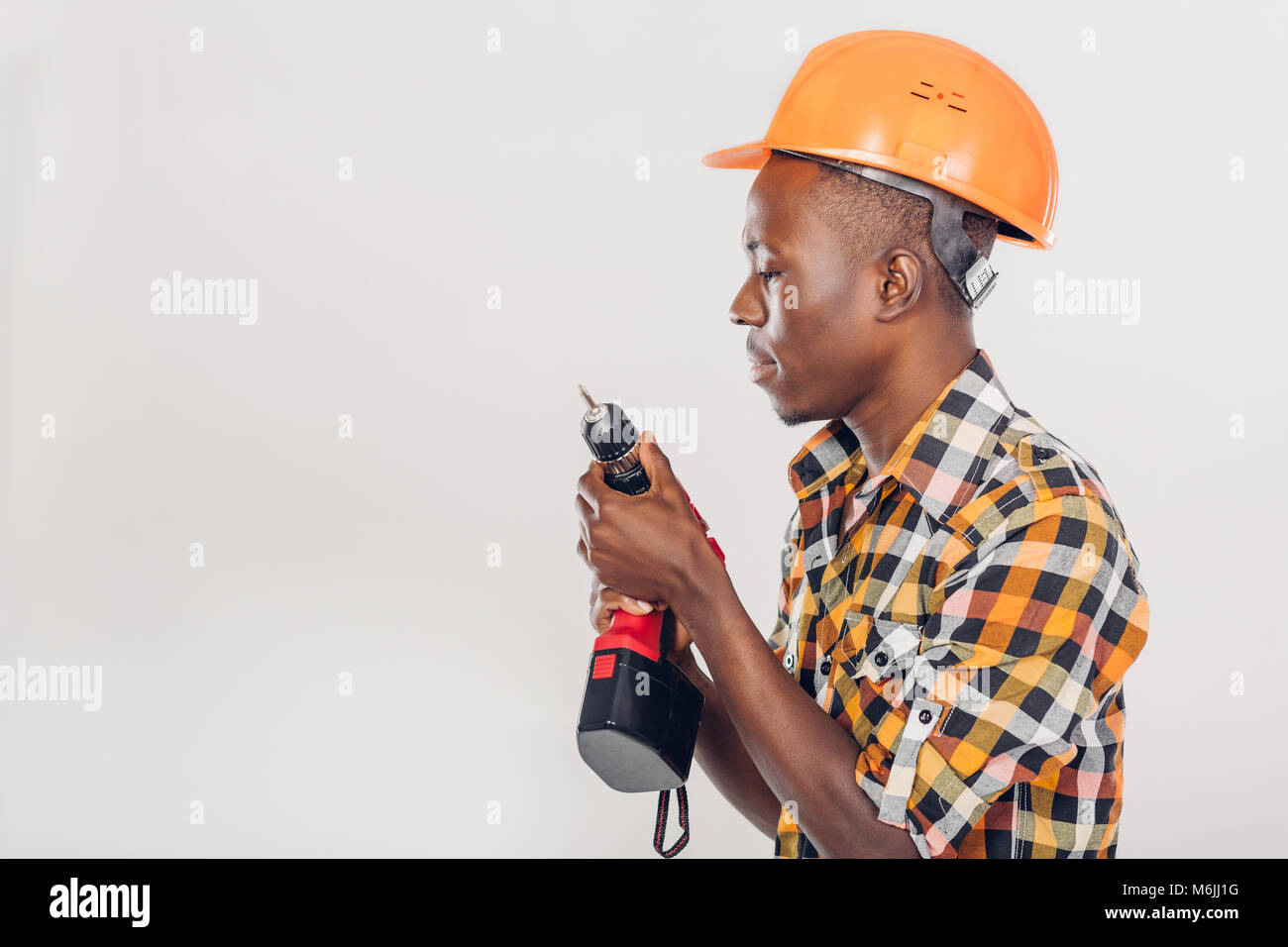 African American worker uses electric screwdriver Stock Photo - Alamy