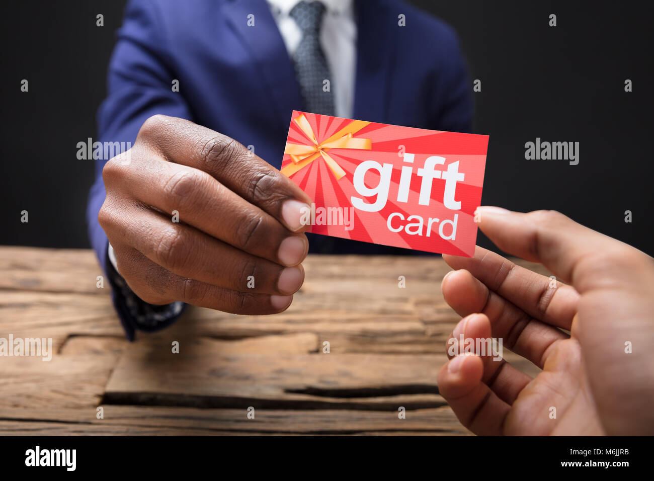 Close-up Of A Businessman's Hand Giving Gift Card To His Partner In ...