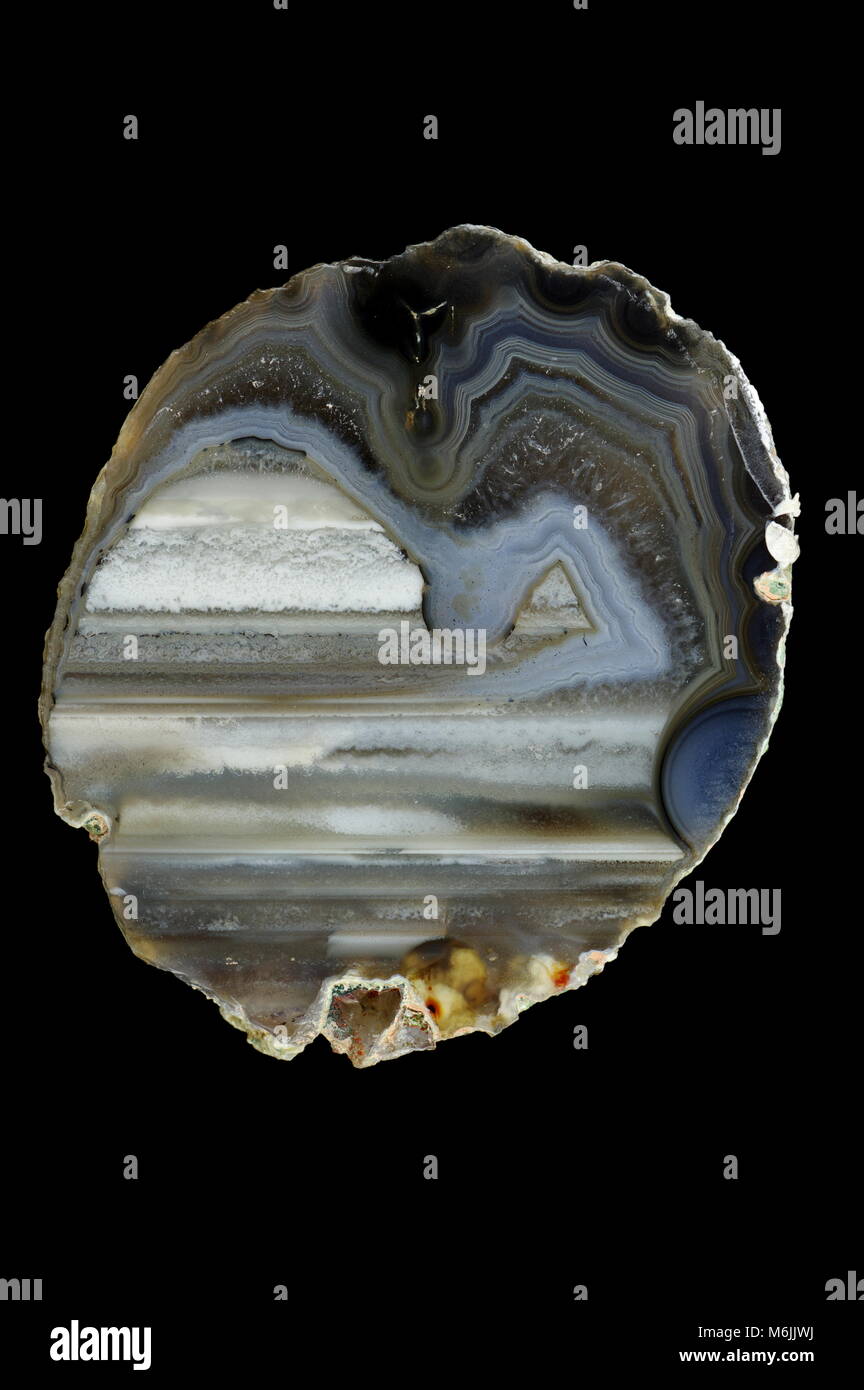 A cross-section of agate. Multicolored silica bands colored with metal ...