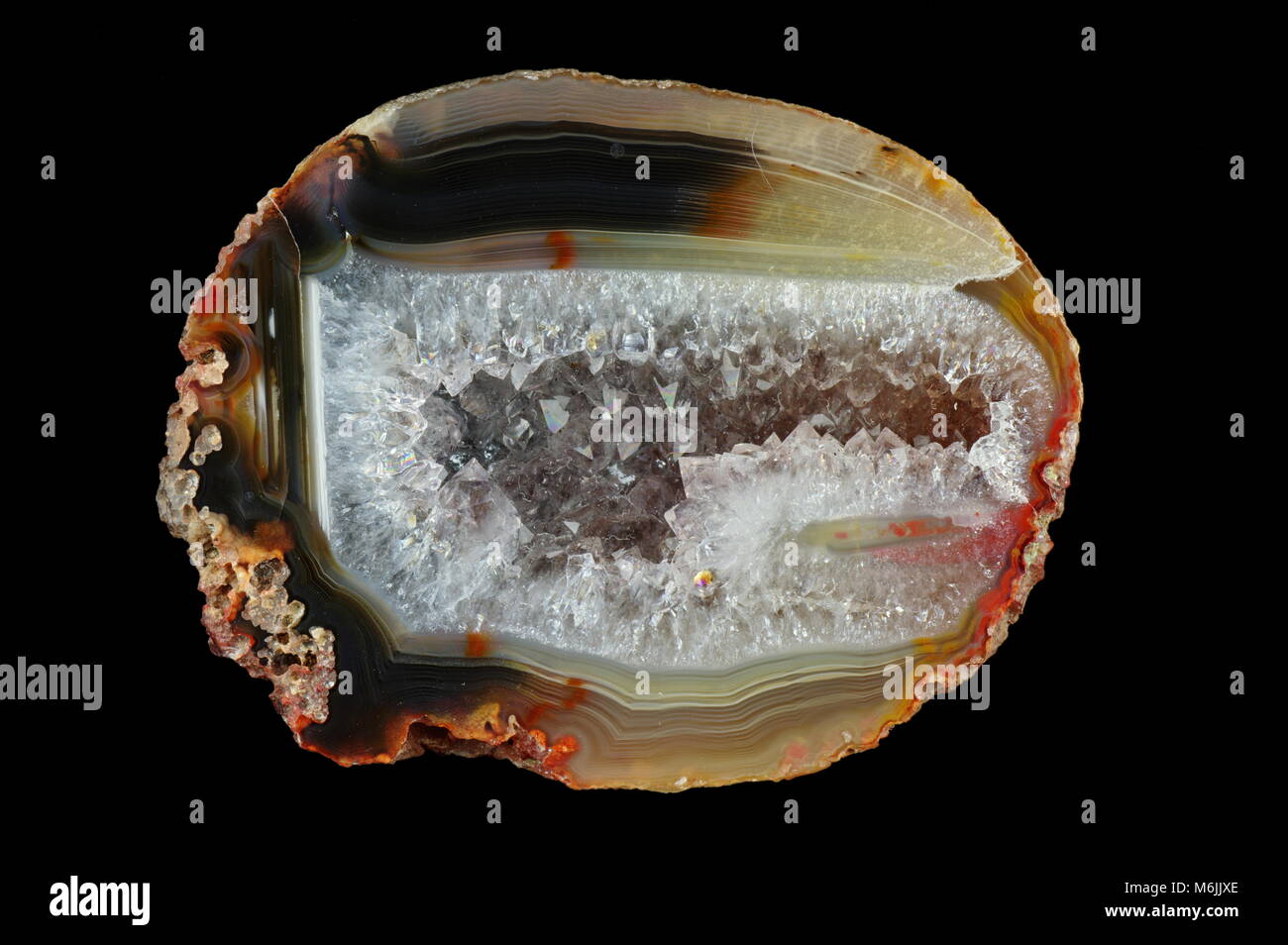 A cross-section of agate. Horizontal agate, filled with quartz, with ...