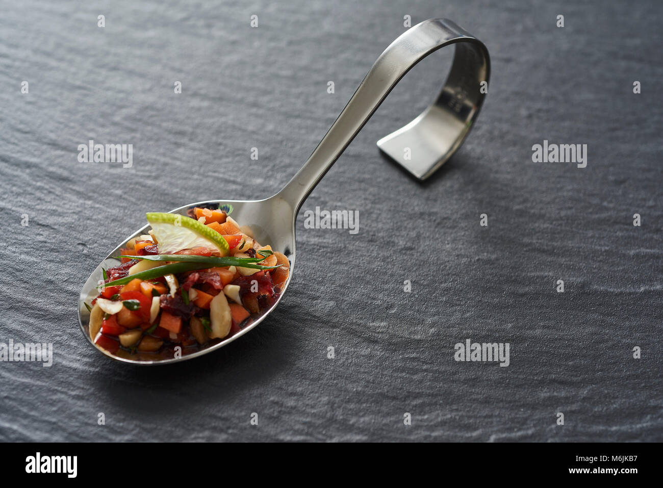 little delicious appetizer on a happy spoon Stock Photo - Alamy