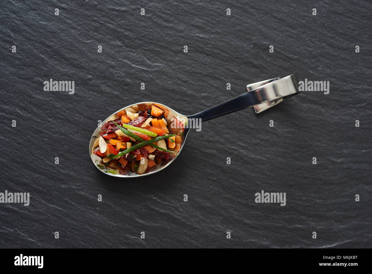 little delicious appetizer on a happy spoon Stock Photo - Alamy