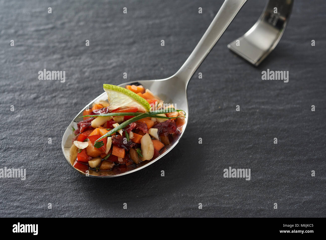 little delicious appetizer on a happy spoon Stock Photo - Alamy