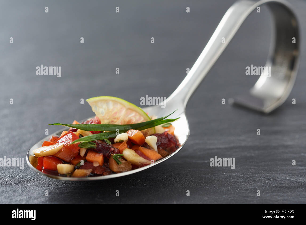 little delicious appetizer on a happy spoon Stock Photo - Alamy