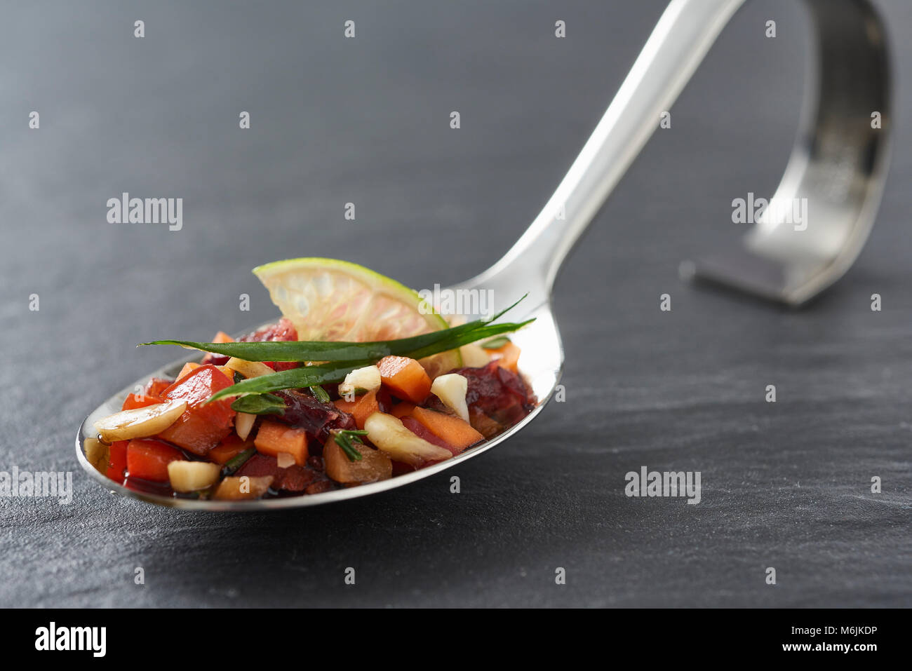 little delicious appetizer on a happy spoon Stock Photo - Alamy