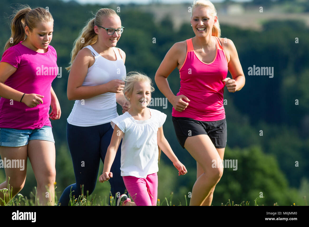 Mother and Children running for better fitness in summer Stock Photo ...