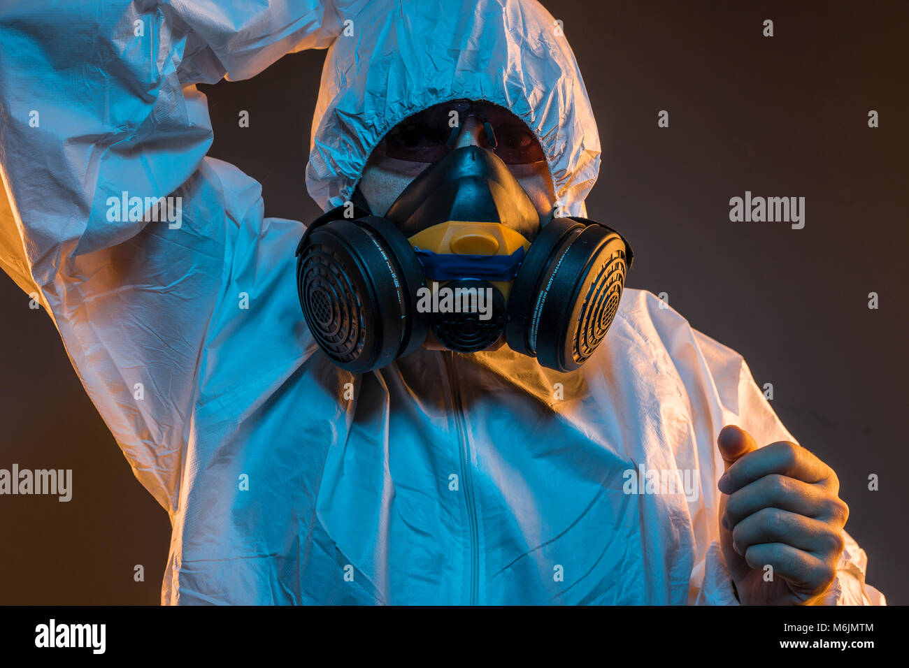 virus infection concept. Man in protective suit and antigas mask with ...