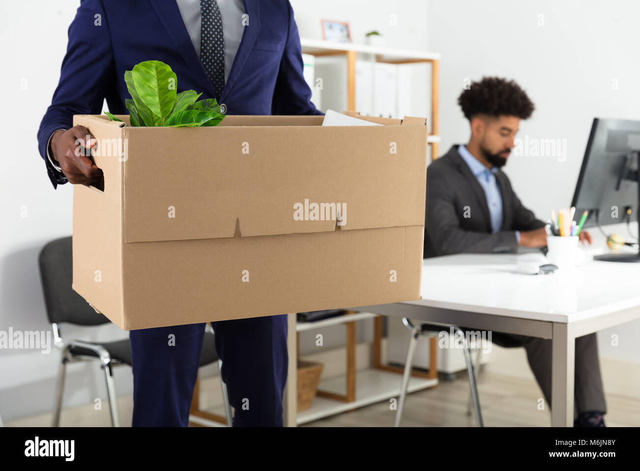 Office person holding box hi-res stock photography and images - Alamy