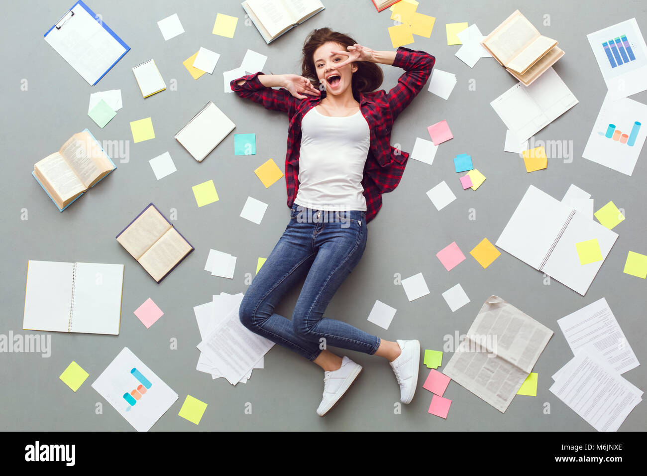 Young woman top view isolated on grey posing joyful Stock Photo - Alamy