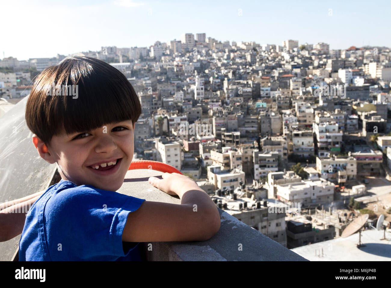 Jerusalem, Israel, November 2, 2010: Palestinian boy on a roof of a ...