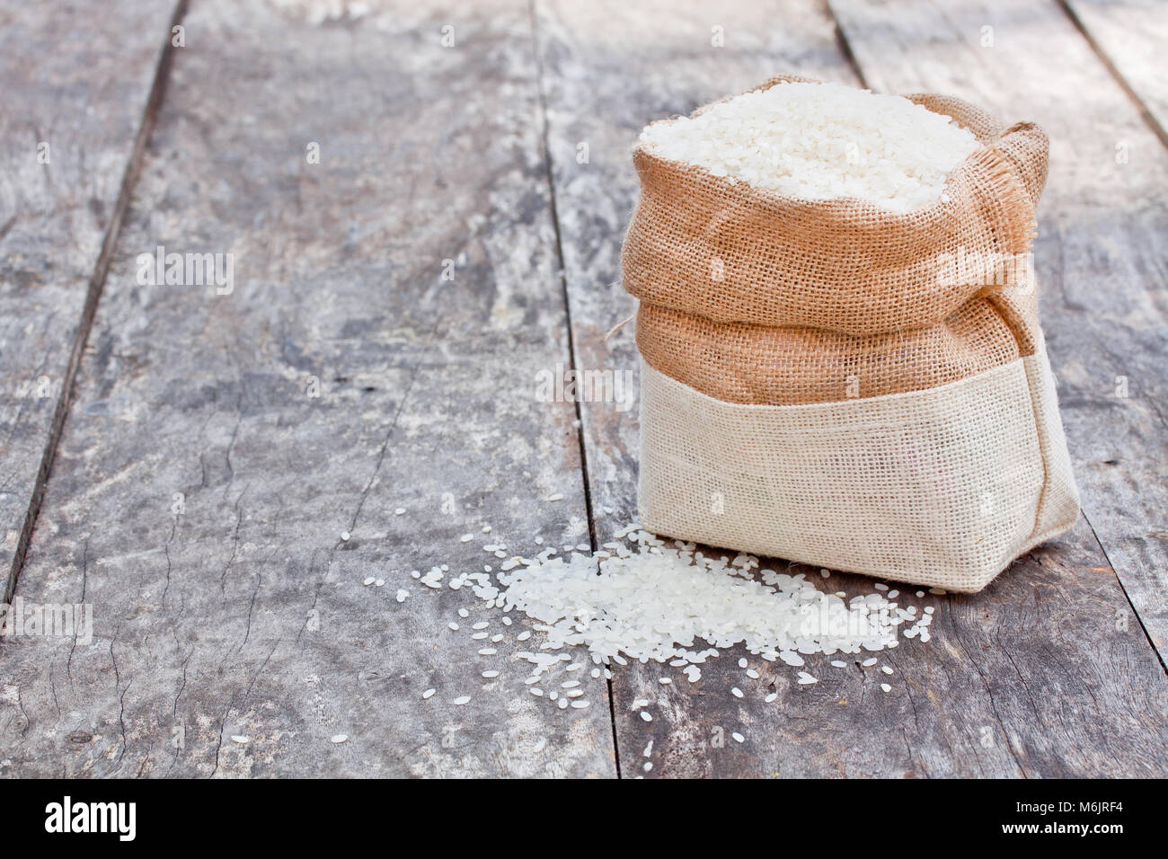 rice bag on the brown oak table Stock Photo - Alamy