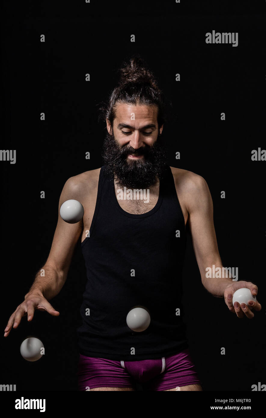 Juggler having fun making his performance at the circus Stock Photo - Alamy