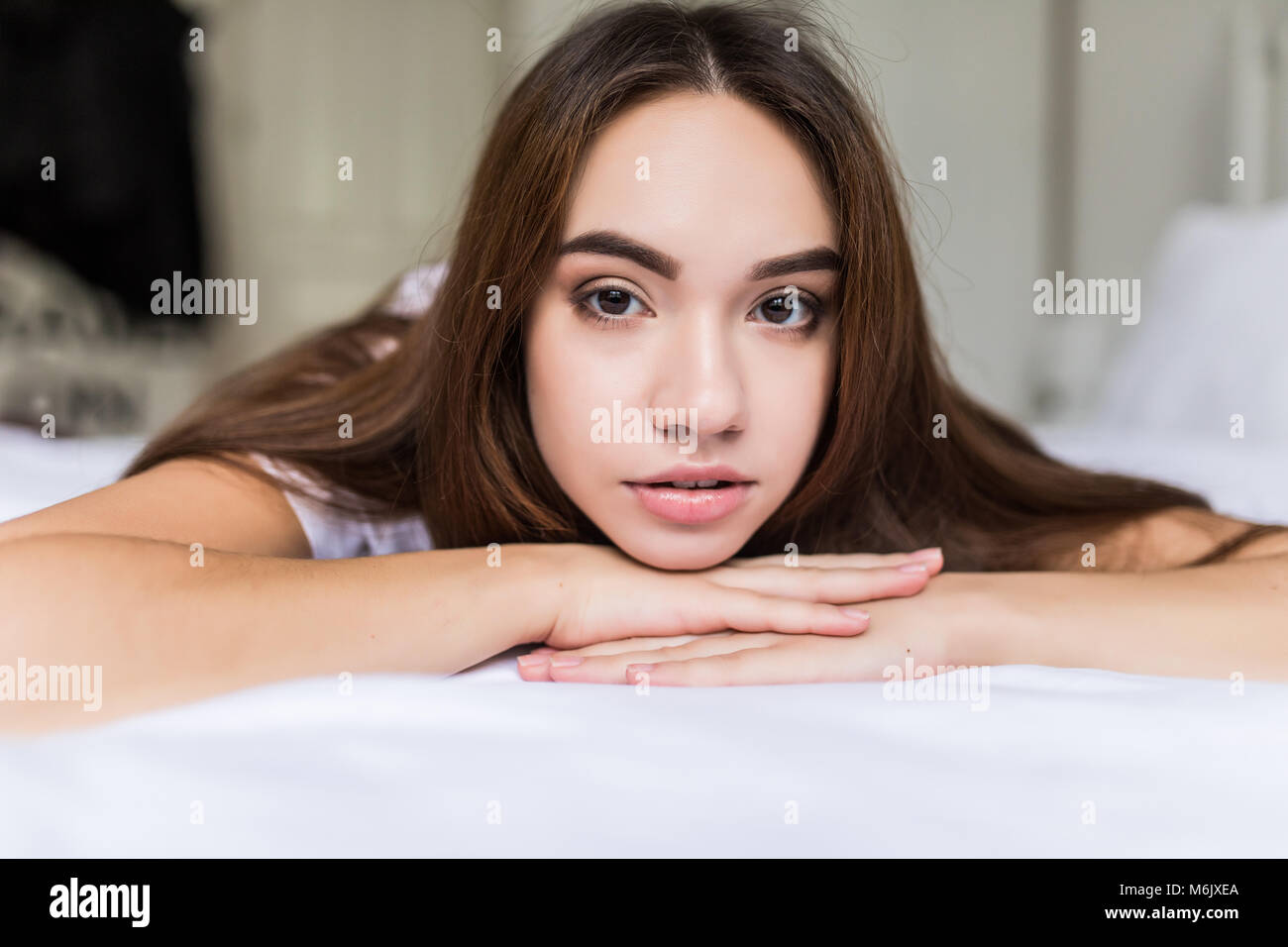 A woman lying on the bed and smiling Stock Photo - Alamy