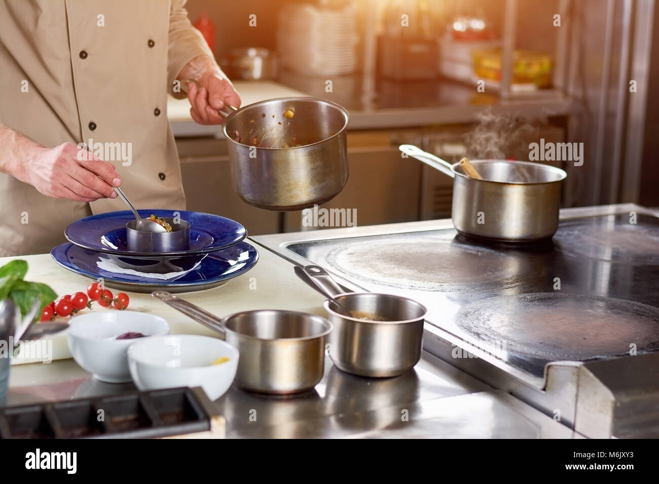 Male chef putting dish in plate Stock Photo - Alamy