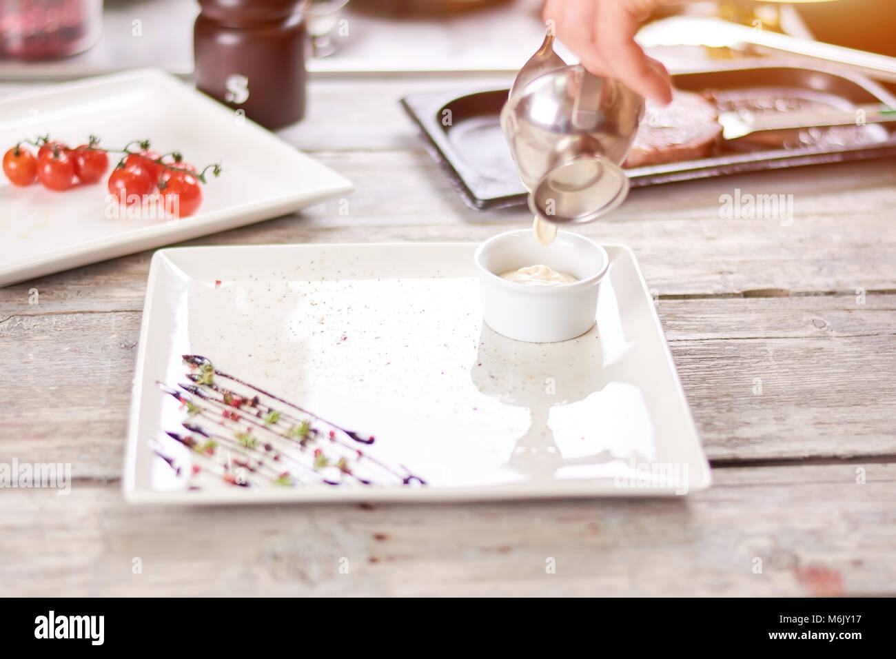 Cream pouring in porcelain dish Stock Photo - Alamy