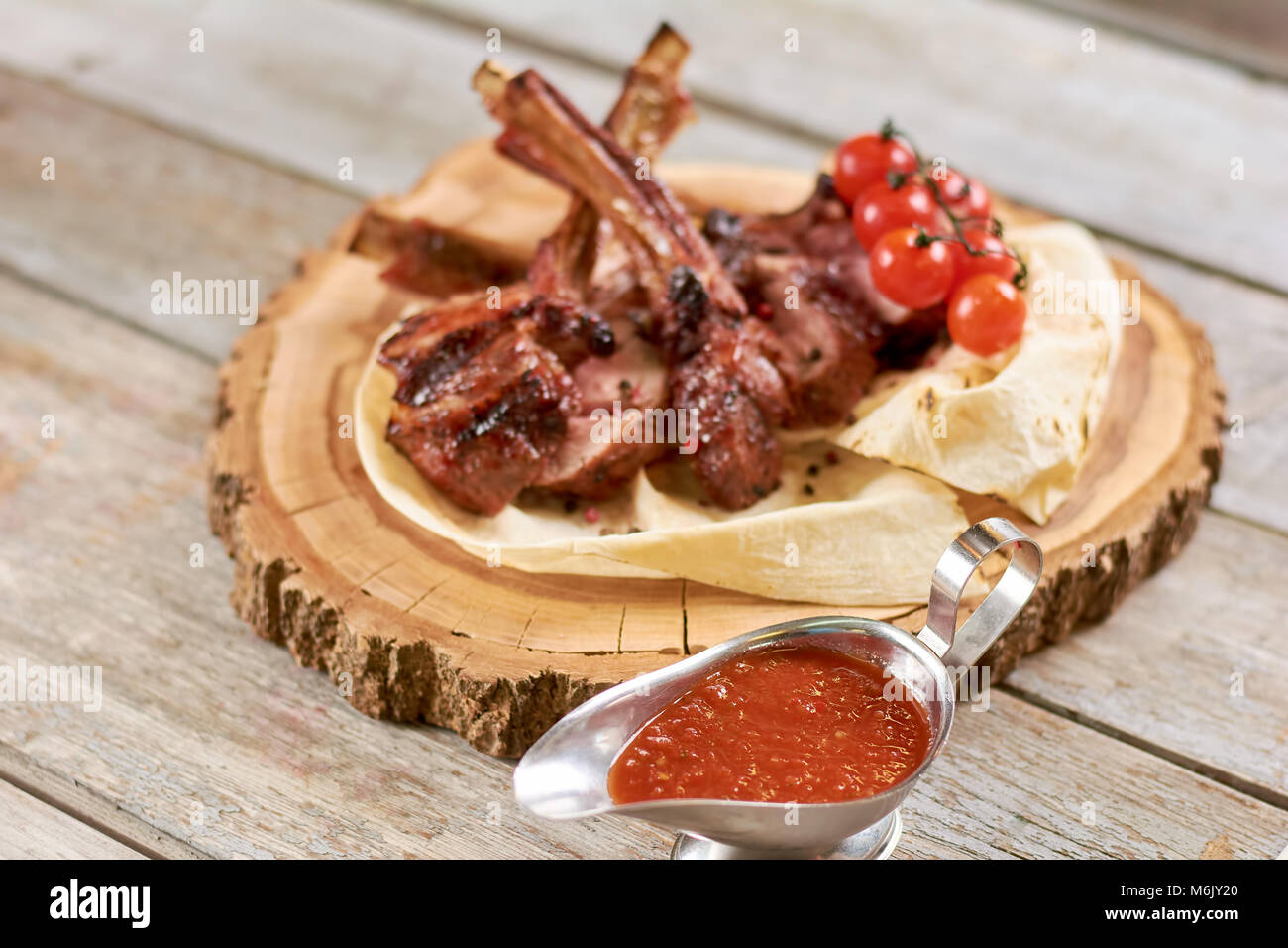 Calf ribs with cherry tomatoes Stock Photo - Alamy
