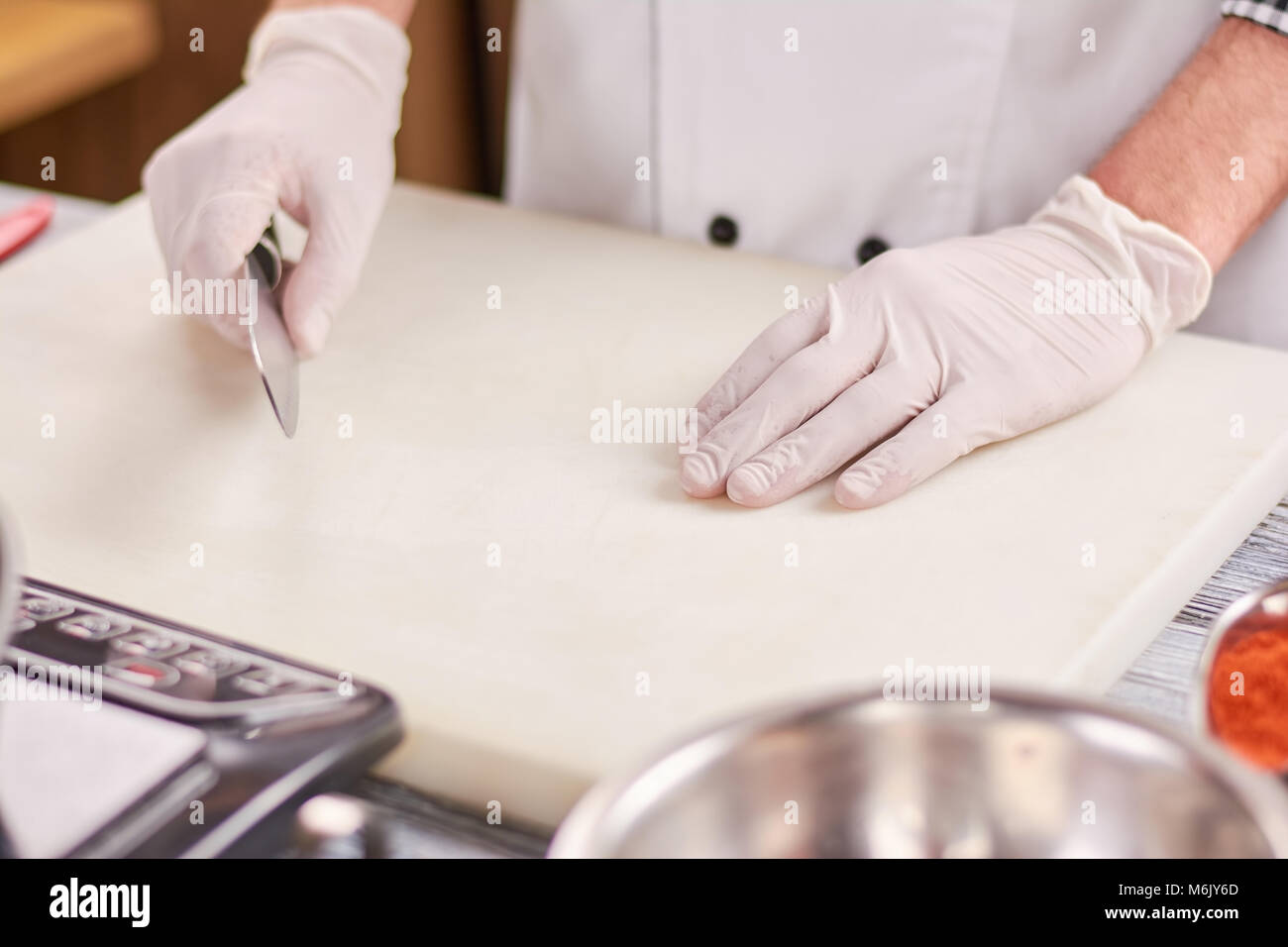 Male chef hands with knife Stock Photo - Alamy