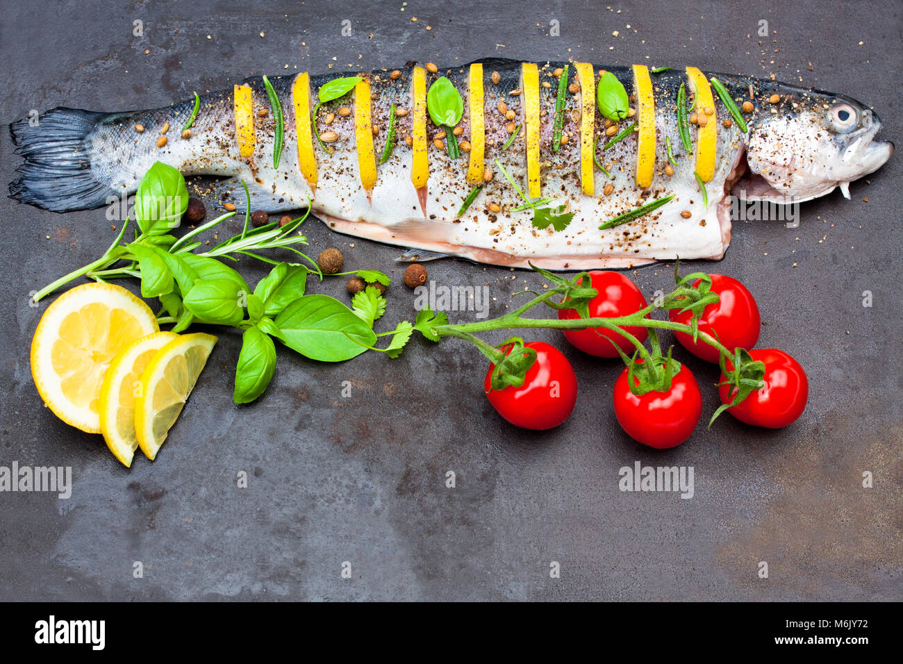lemon stuffed whole trout with spices on the metallic tray Stock Photo ...
