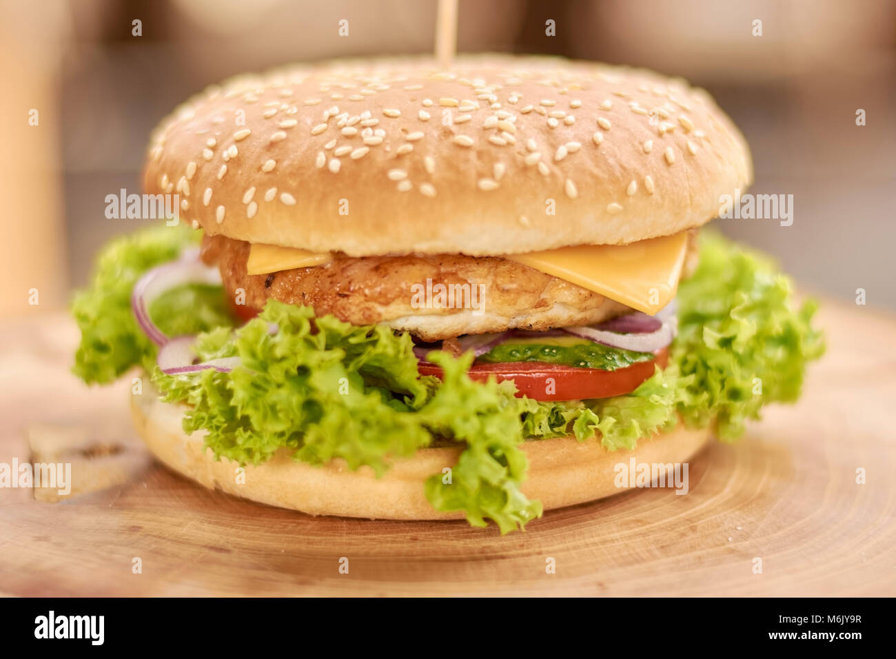 Fresh chicken burger on wooden background Stock Photo - Alamy