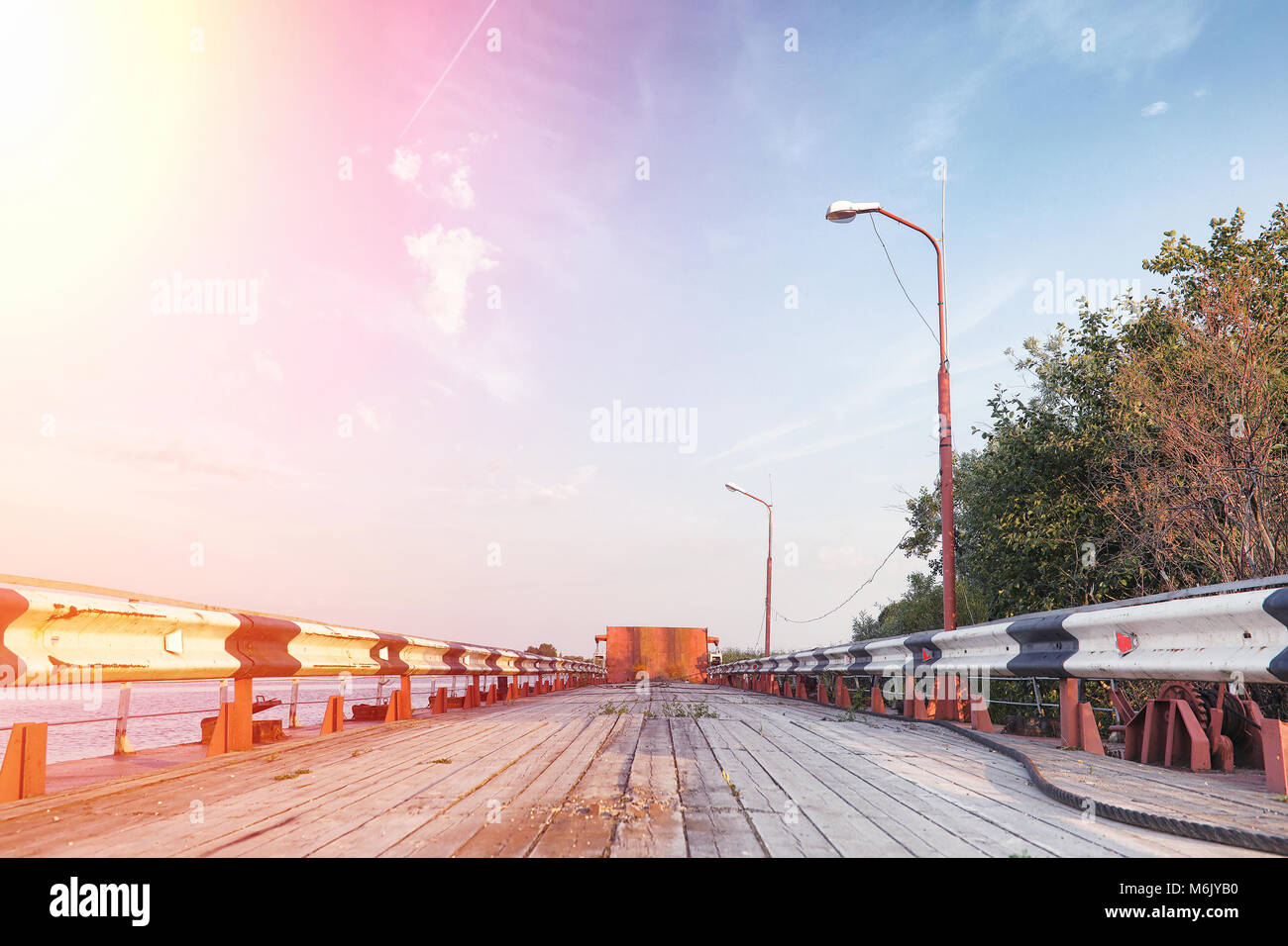 Wooden bridge on the river bank. A wooden road with pillars. Pan Stock ...