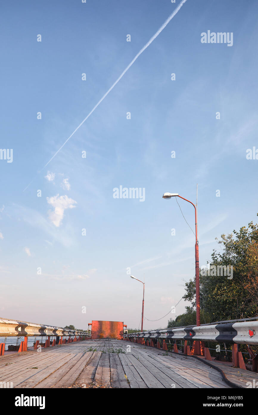 Wooden bridge on the river bank. A wooden road with pillars. Pan Stock ...