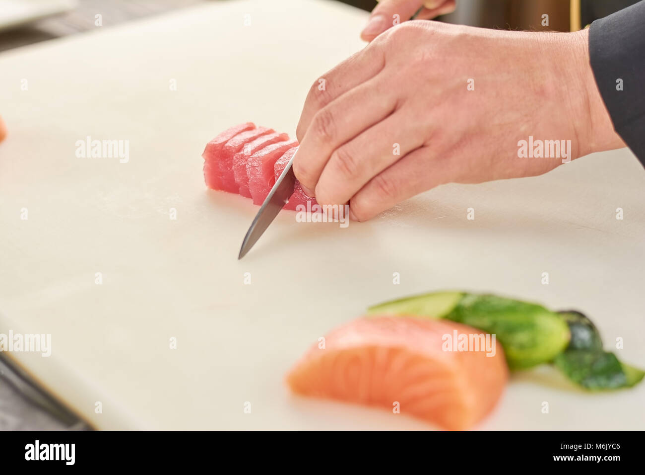 Hands slicing raw fish hi-res stock photography and images - Alamy