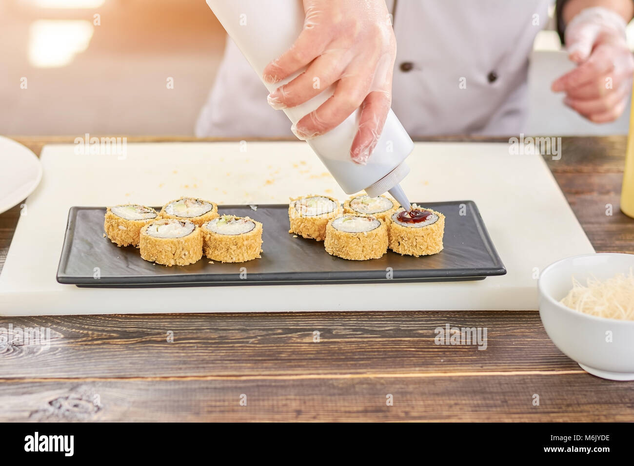 Chef pouring sushi with sauce Stock Photo - Alamy