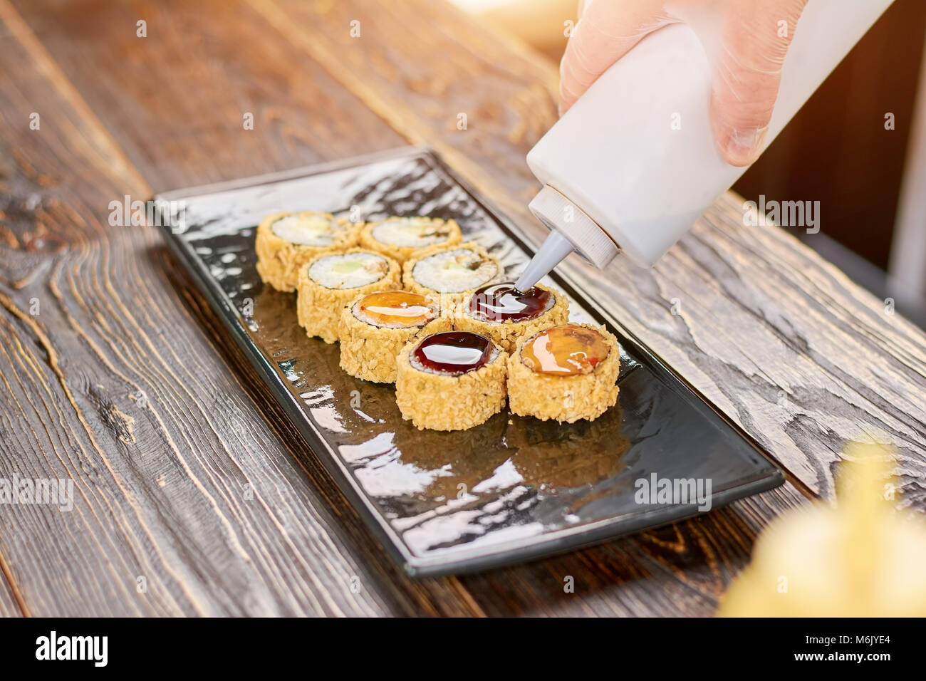 Japanese sushi roll pouring with soy sauce Stock Photo - Alamy