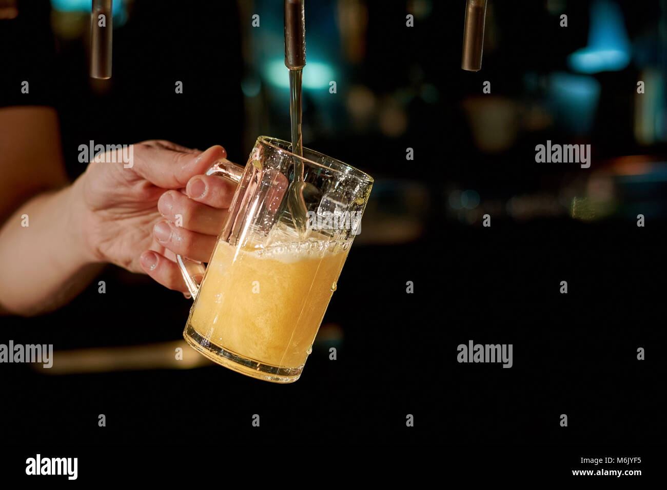 Close up bartender hand pouring beer Stock Photo - Alamy