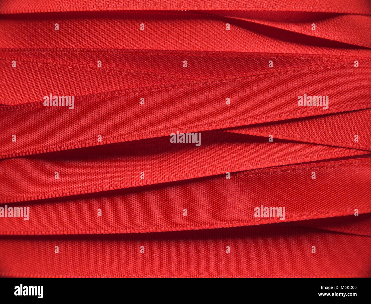Shiny red satin ribbon background Stock Photo - Alamy