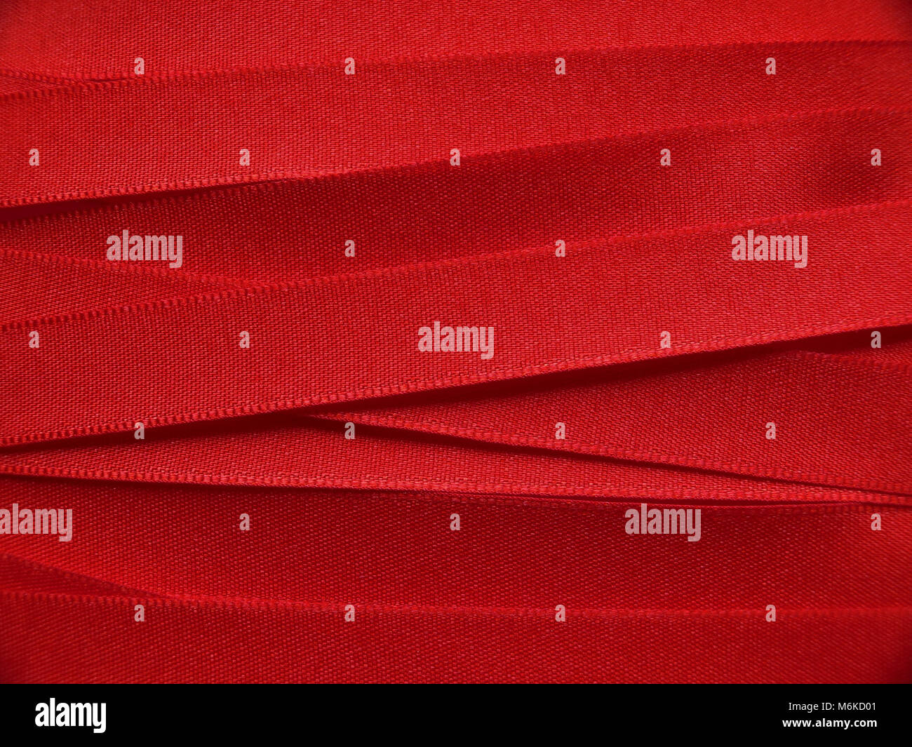 Shiny red satin ribbon background Stock Photo - Alamy