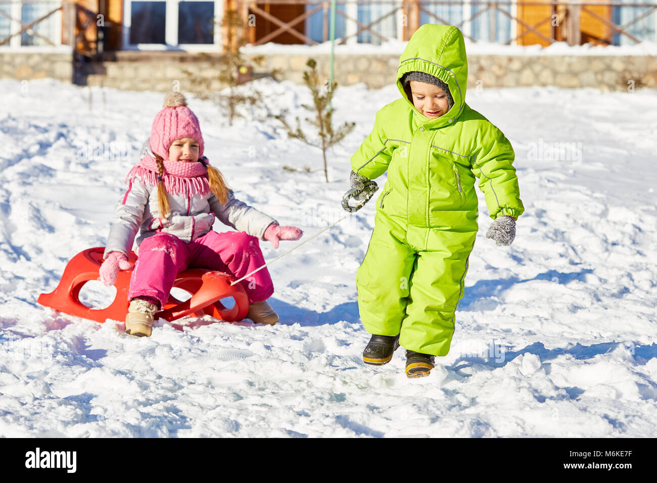 Kids sledding on winter day Stock Photo - Alamy