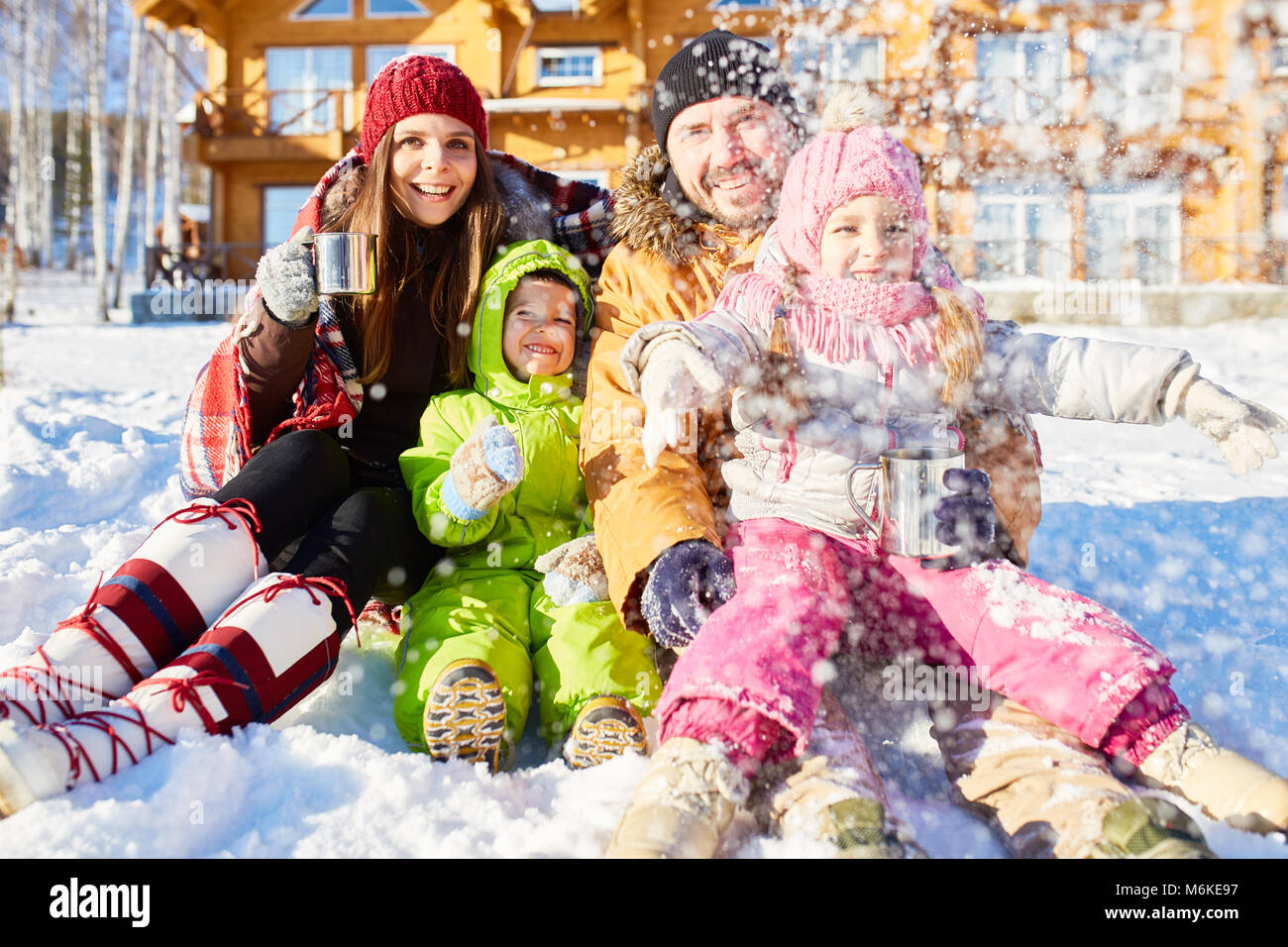 Parents and kids enjoying winter Stock Photo - Alamy