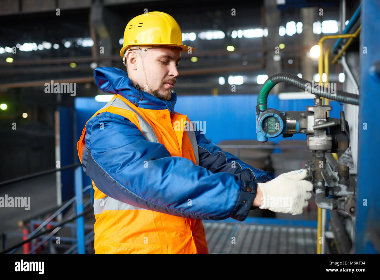 Handsome Worker Adjusting Equipment Stock Photo - Alamy