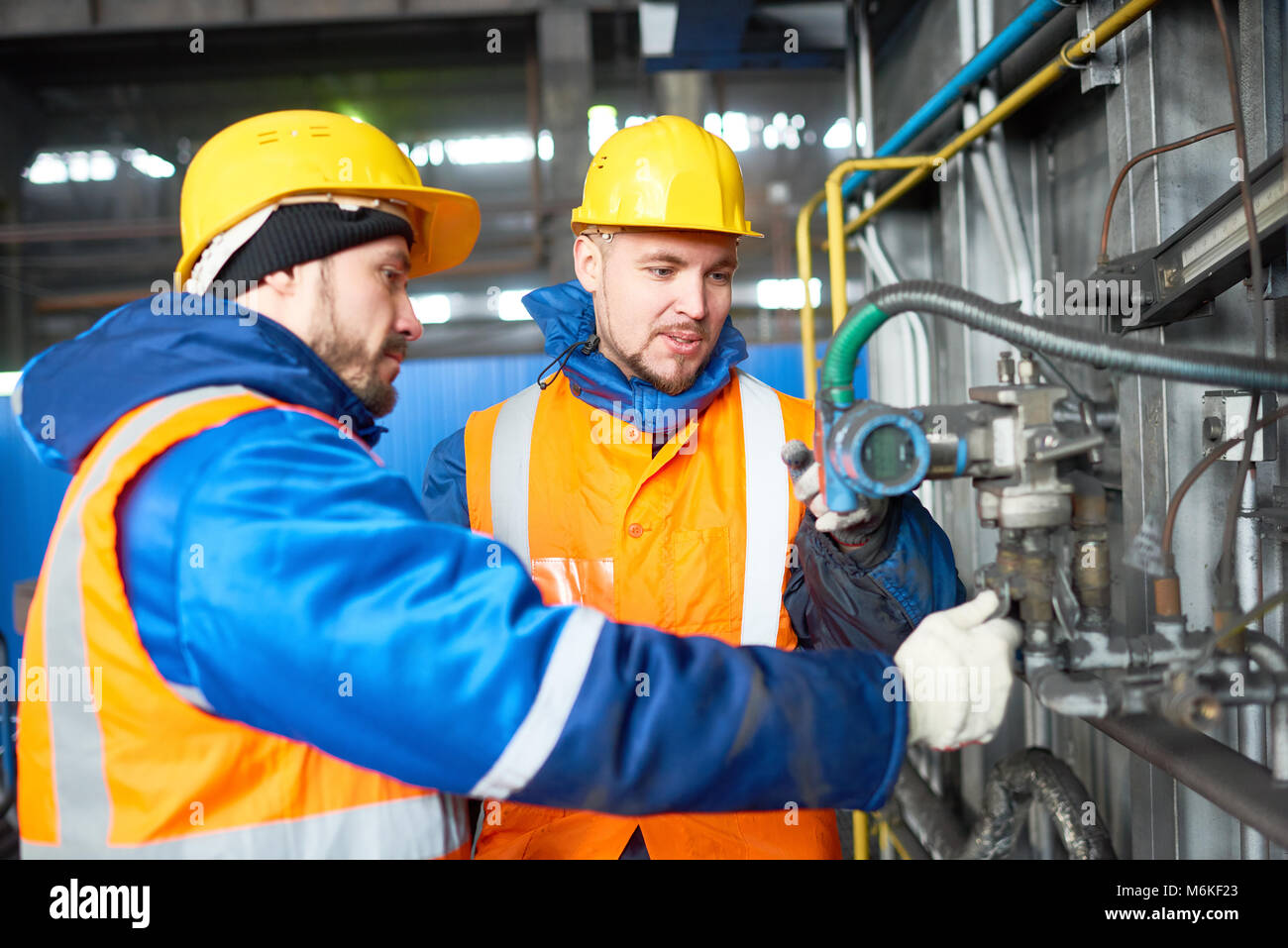 Team Adjusting Equipment Stock Photo - Alamy
