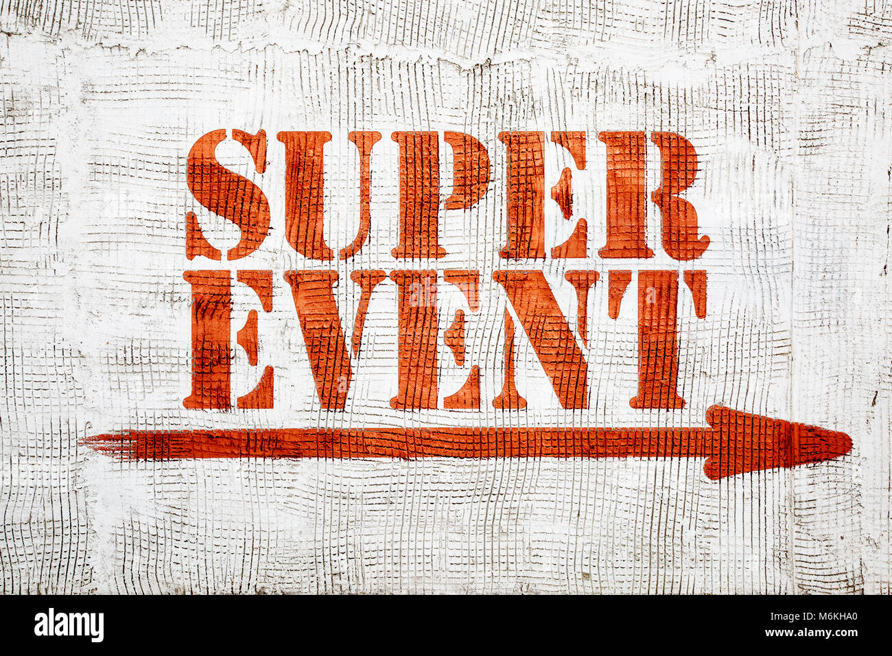 Super event - red graffiti sign with arrow on a white stucco wall Stock ...