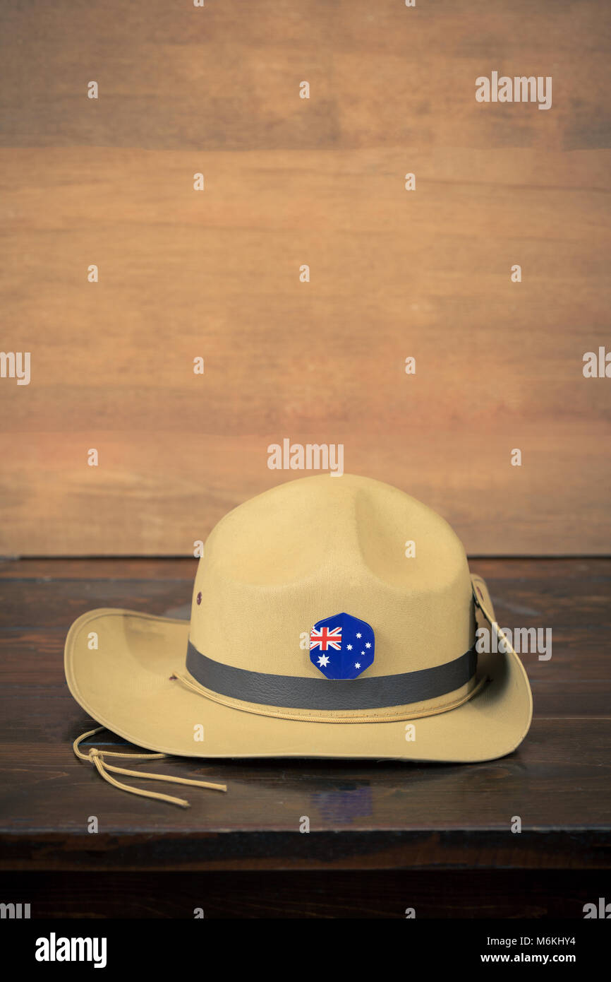 Anzac army slouch hat with Australian Flag on vintage wood background ...