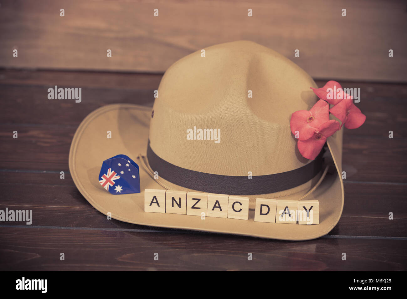 Anzac army slouch hat with Australian Flag on vintage wood background ...