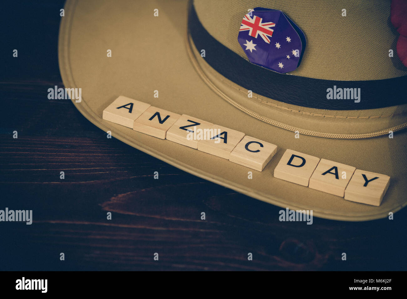 Anzac army slouch hat with Australian Flag on vintage wood background ...